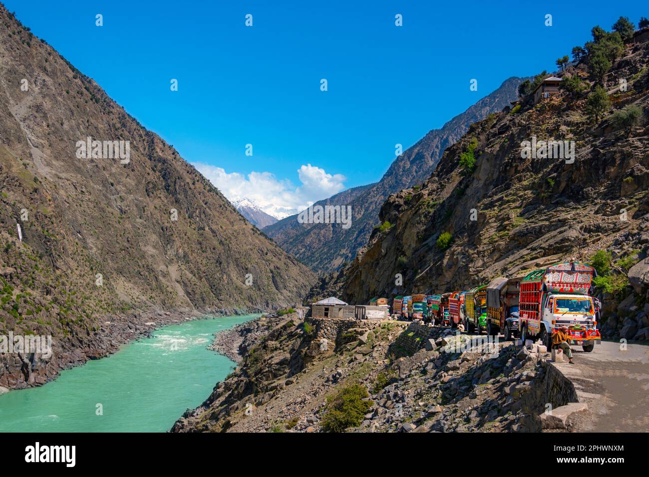 landscape of snow mountains and road with colorful trucks , beautiful ...