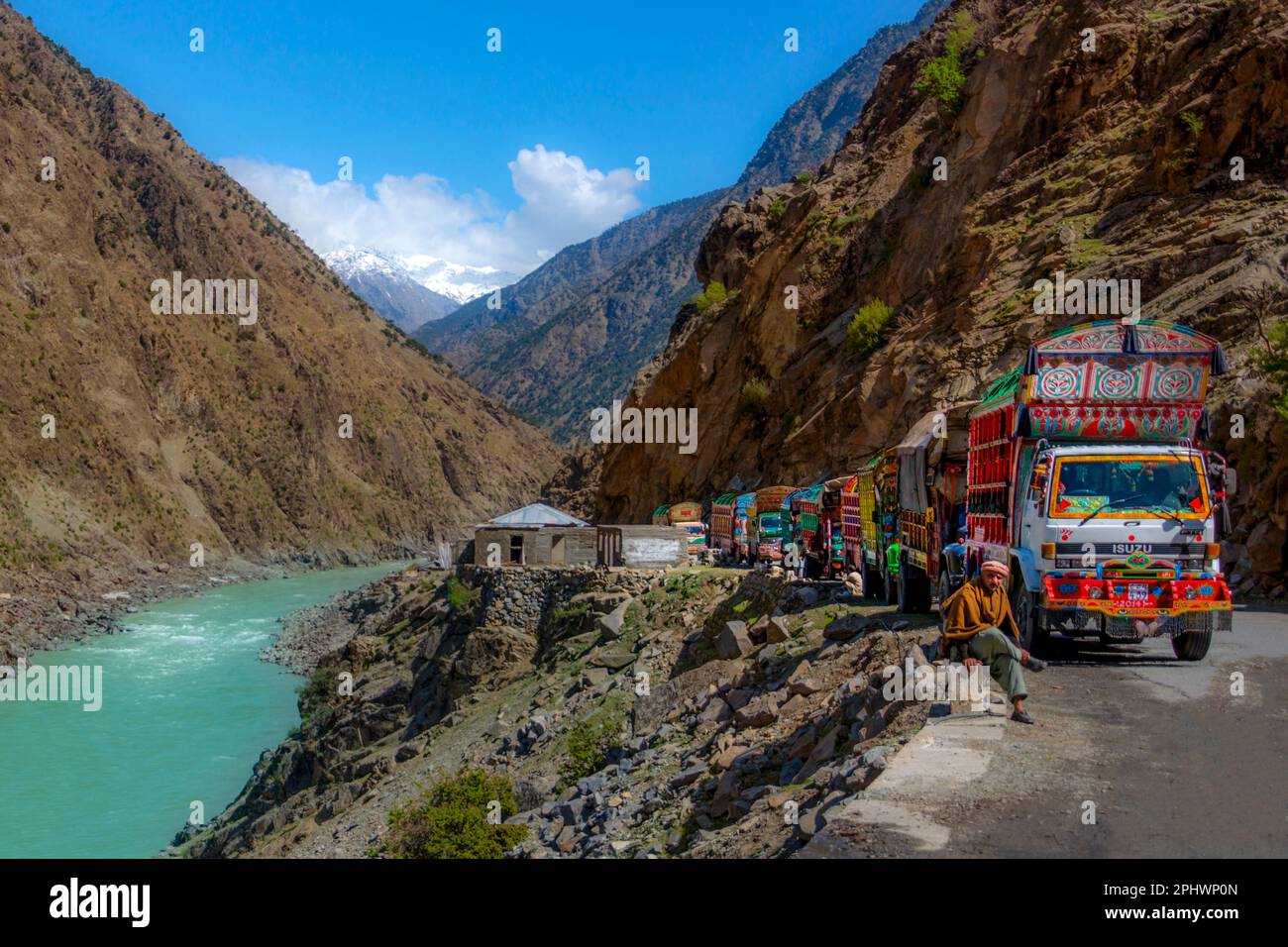 landscape of snow mountains and road with colorful trucks , beautiful ...