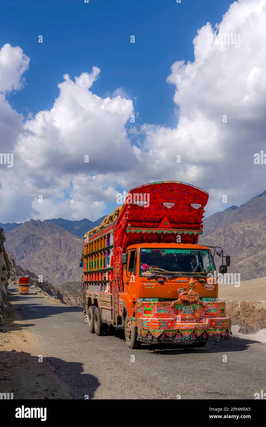 landscape of snow mountains and road with colorful trucks , beautiful ...