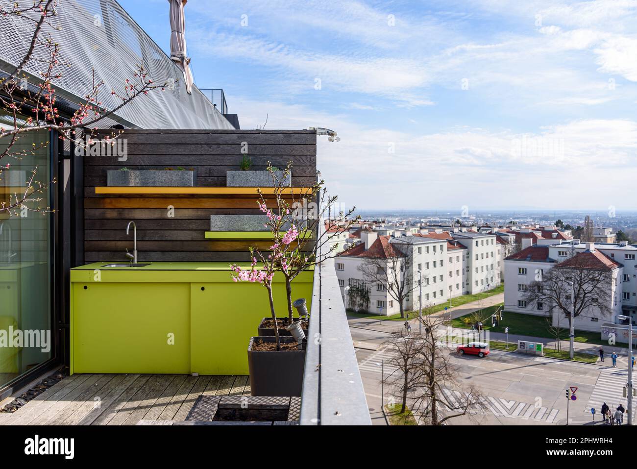 Beautiful roof terrace with wooden floor with yellow and green planters ...