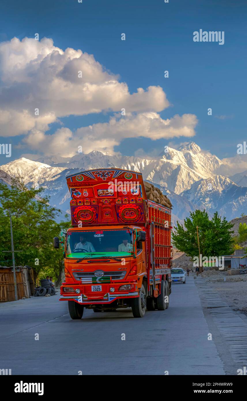 landscape of snow mountains and road with colorful trucks , beautiful decorated Pakistani trucks ...