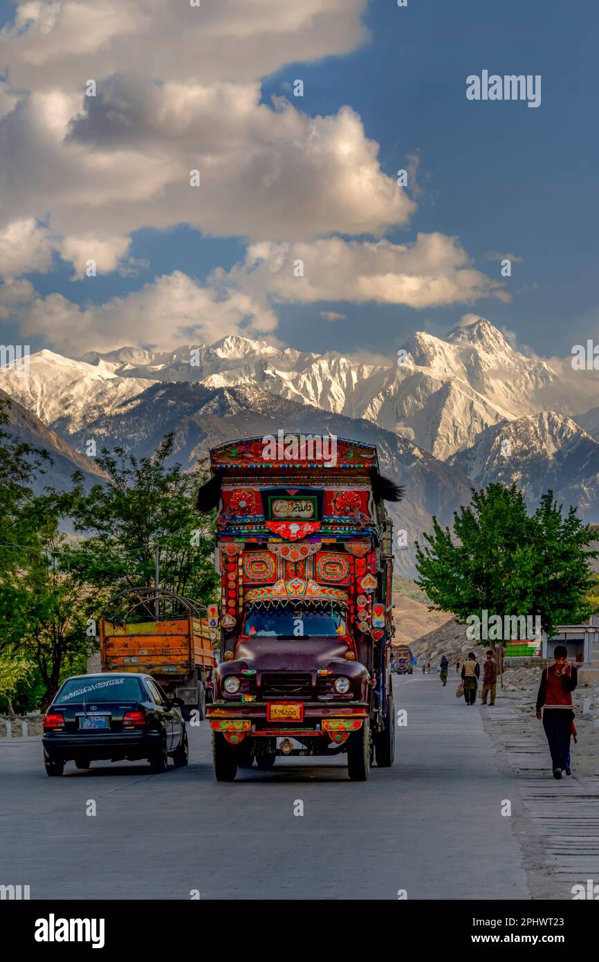 landscape of snow mountains and road with colorful trucks , beautiful ...