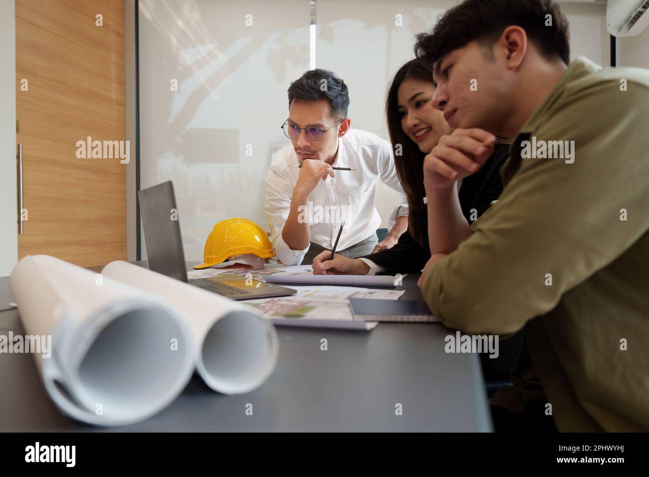 Architect and Engineer working with blueprints for architectural plan ...