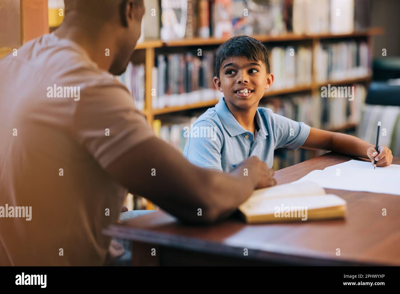 school boy getting academic support from his teacher. Elementary school ...