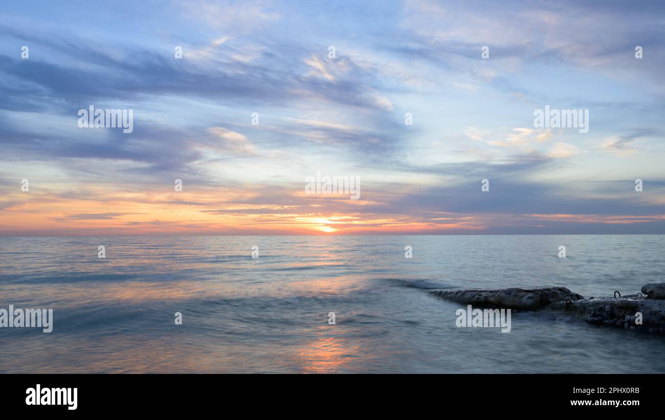 Sunset at the beach in Ault (France) on a cloudy evening in summer ...