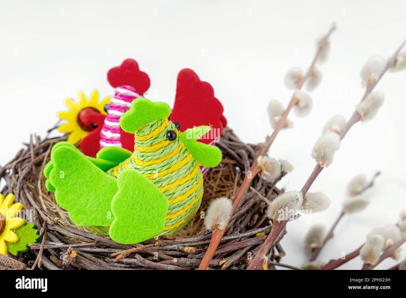 Easter still life. Easter stylized chickens in a nest with a bouquet of ...
