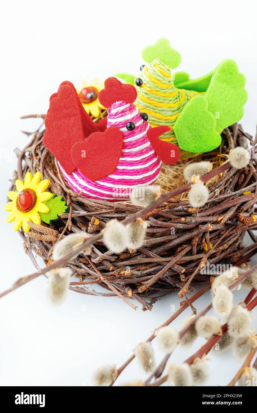 Easter still life. Easter stylized chickens in a nest with a bouquet of ...