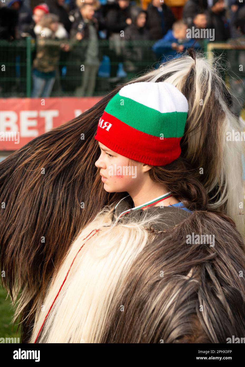 Girl Kukeri dancer called Babuger with mask off at the annual Simitlia ...