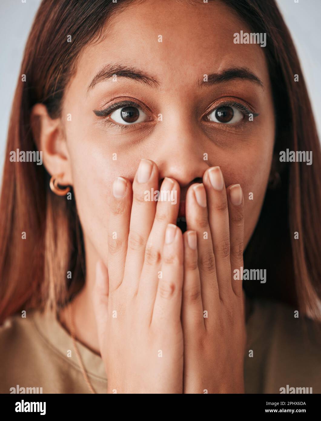 Portrait, woman closeup and surprise in a studio with a female cover ...