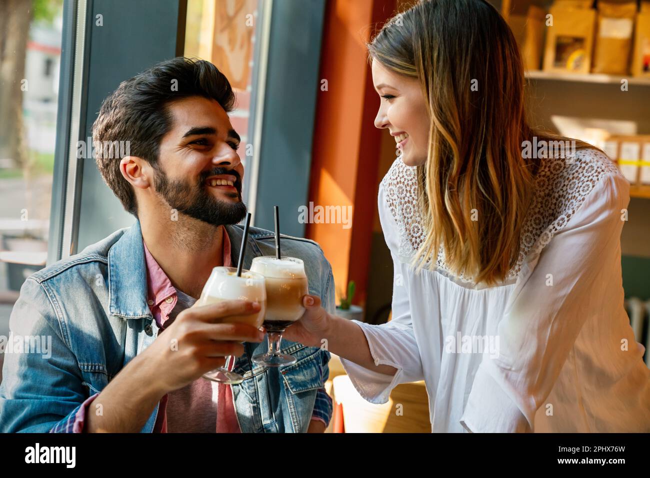 Romantic couple in cafe is drinking coffee and enjoying being together ...