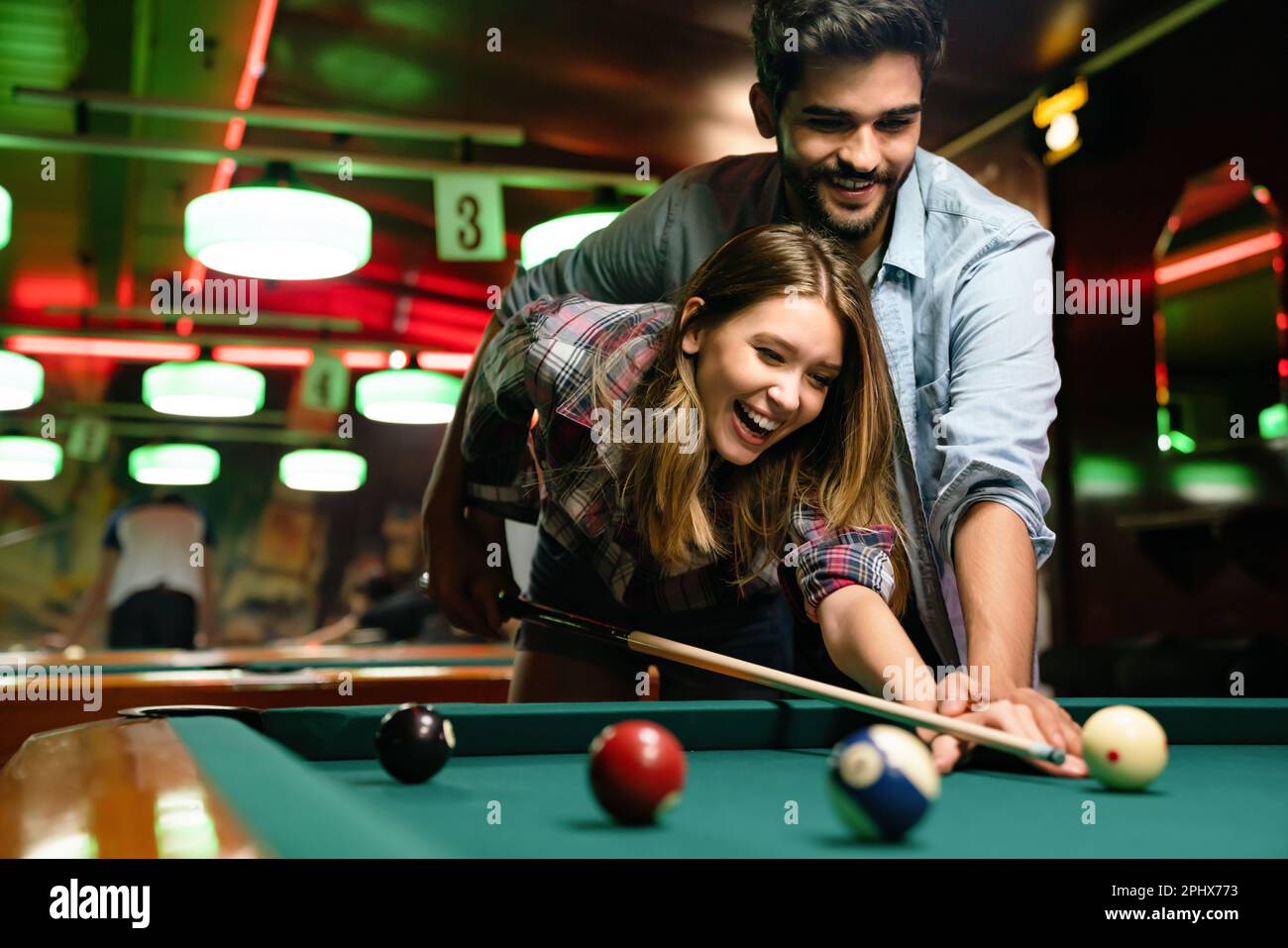 Couple playing billiards standing billiards hi-res stock photography ...