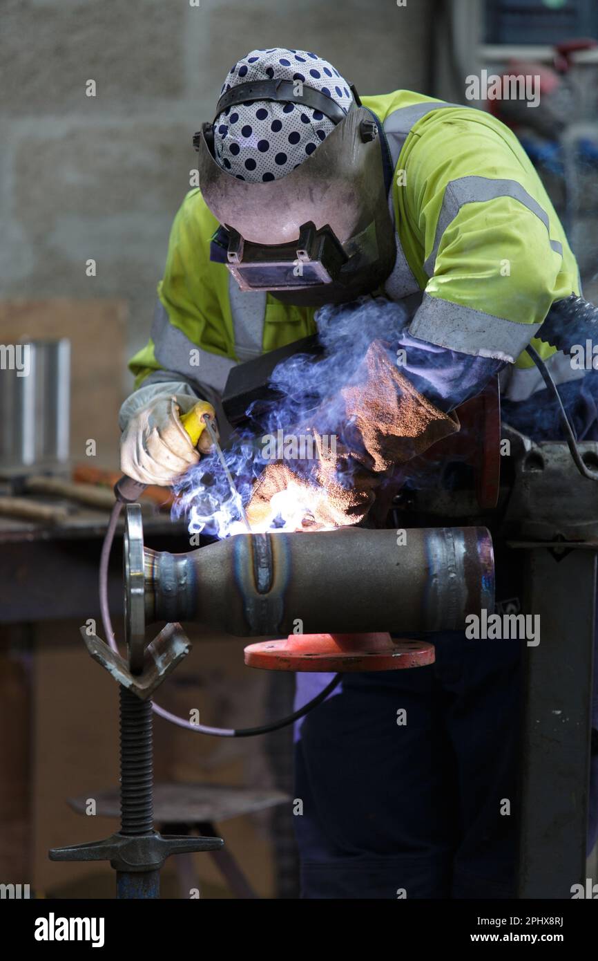 man soldering in a factory Stock Photo - Alamy