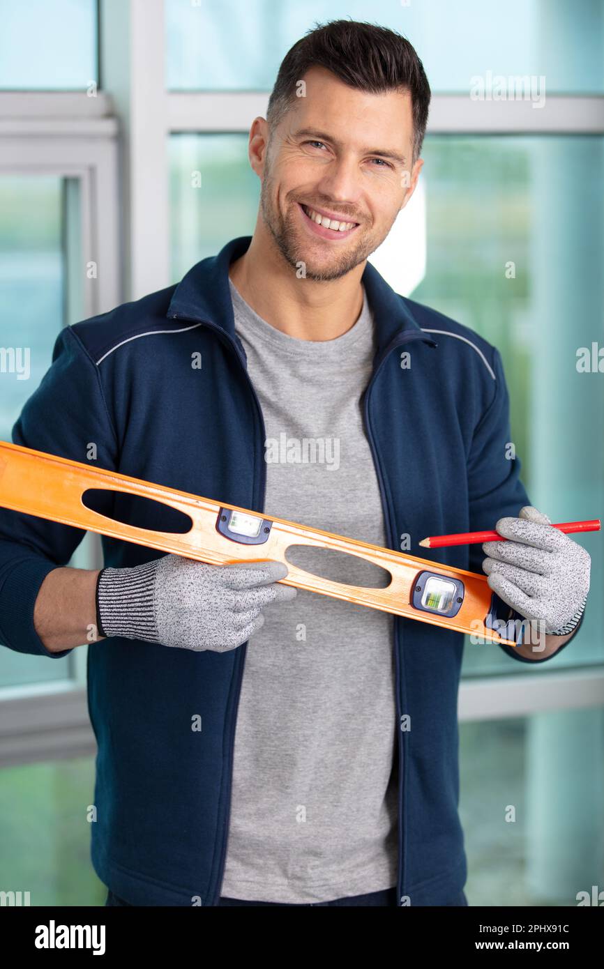 maintenance worker man holding aluminium spirit level Stock Photo - Alamy