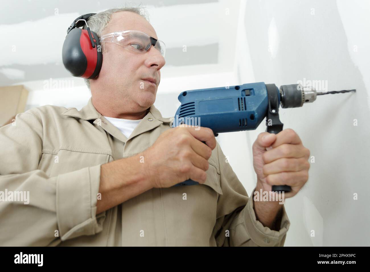 Man using old drill hi-res stock photography and images - Alamy