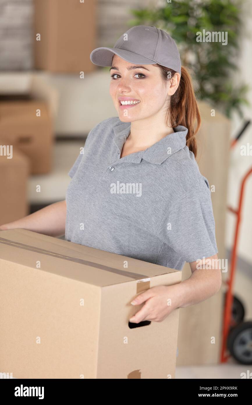 delivery person delivering packages holding clipboard and package ...