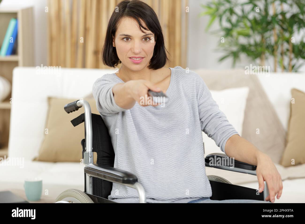 disabled woman in wheelchair watching tv in the living room Stock Photo ...