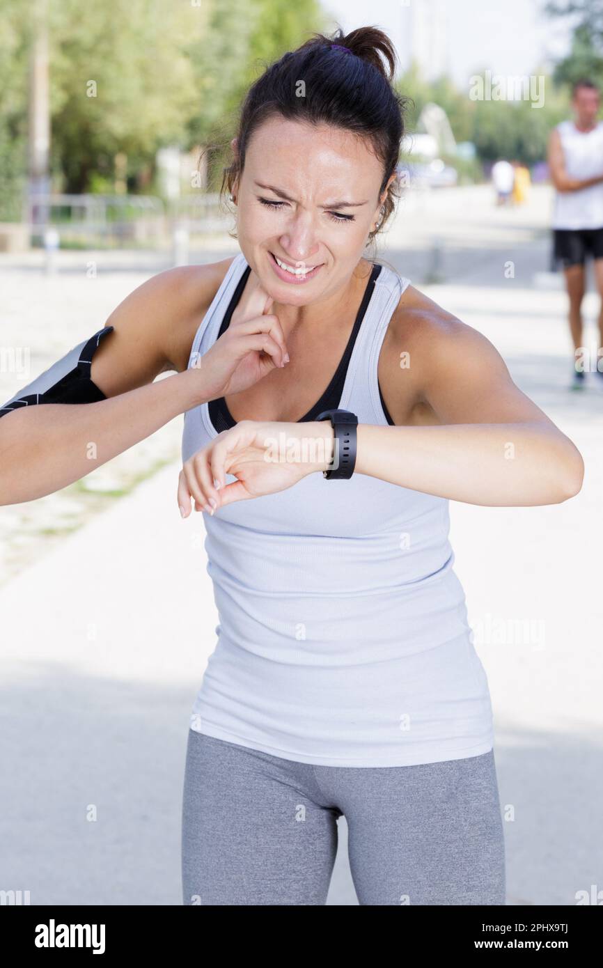 woman running outdoors using watch Stock Photo - Alamy