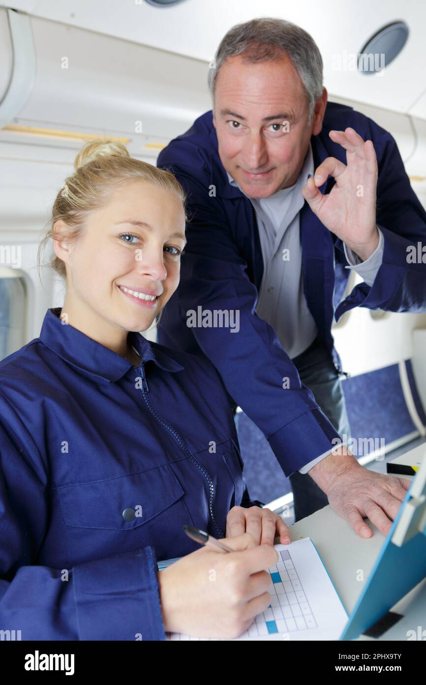 happy workers on final assembly line of aircraft Stock Photo - Alamy