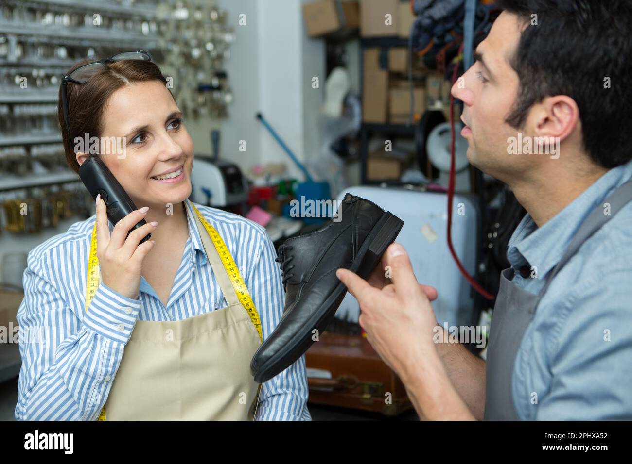 female shoemaker on the phone talking to customer Stock Photo - Alamy