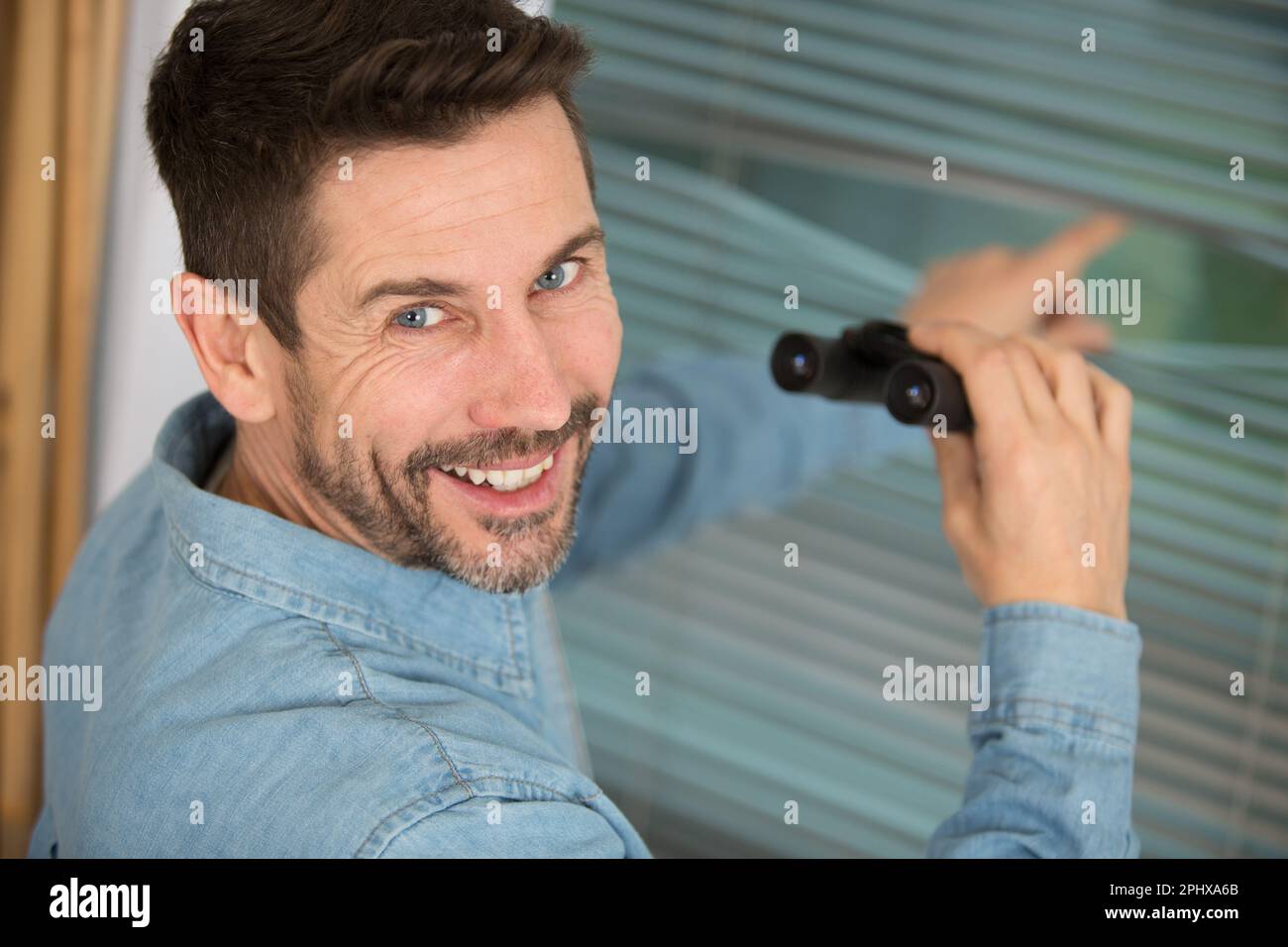Man peeking out window hi-res stock photography and images - Alamy