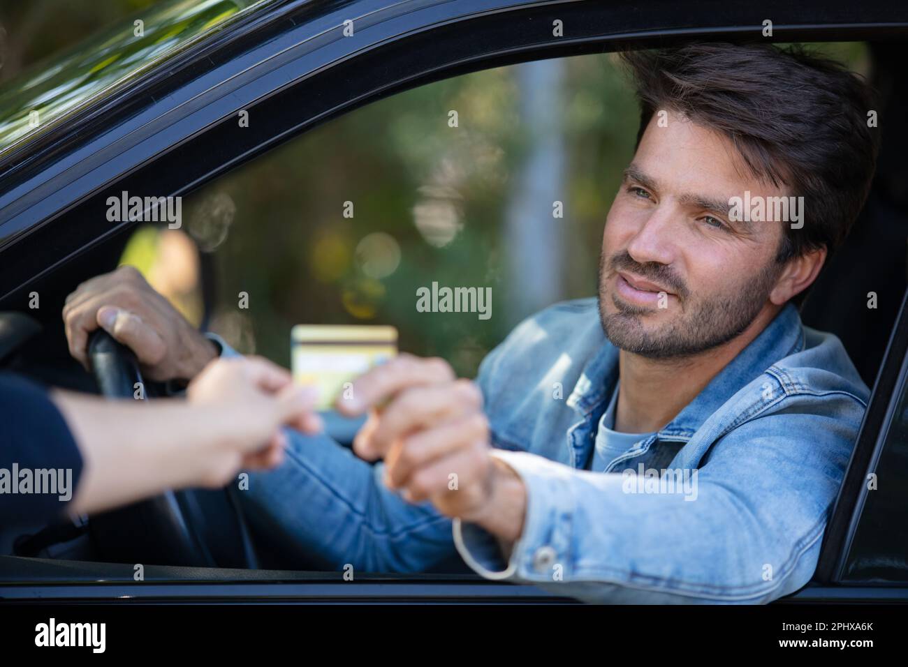 male driver making payment by card Stock Photo - Alamy
