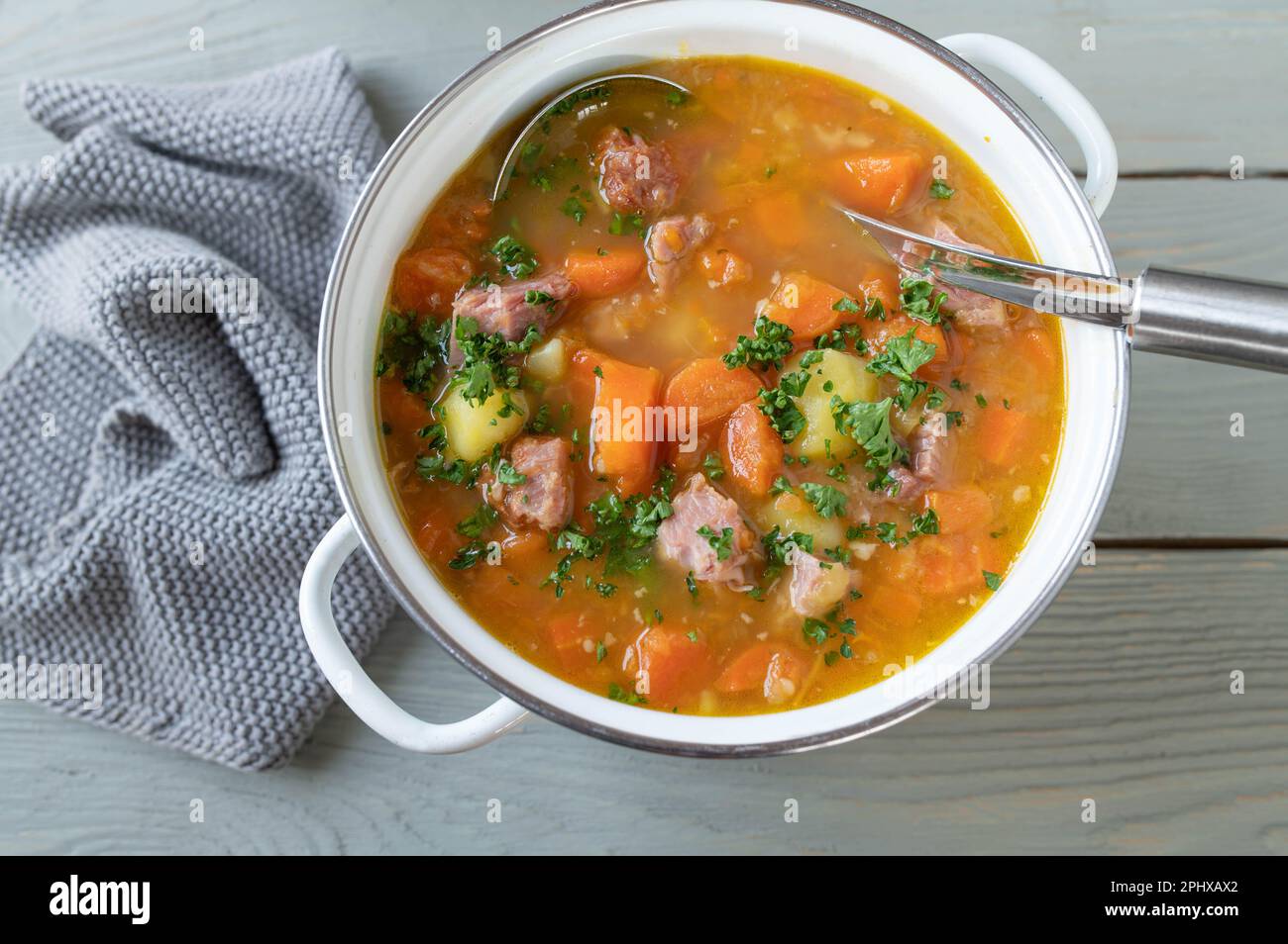 Carrot stew with potatoes and smoked pork meat in a pot Stock Photo - Alamy