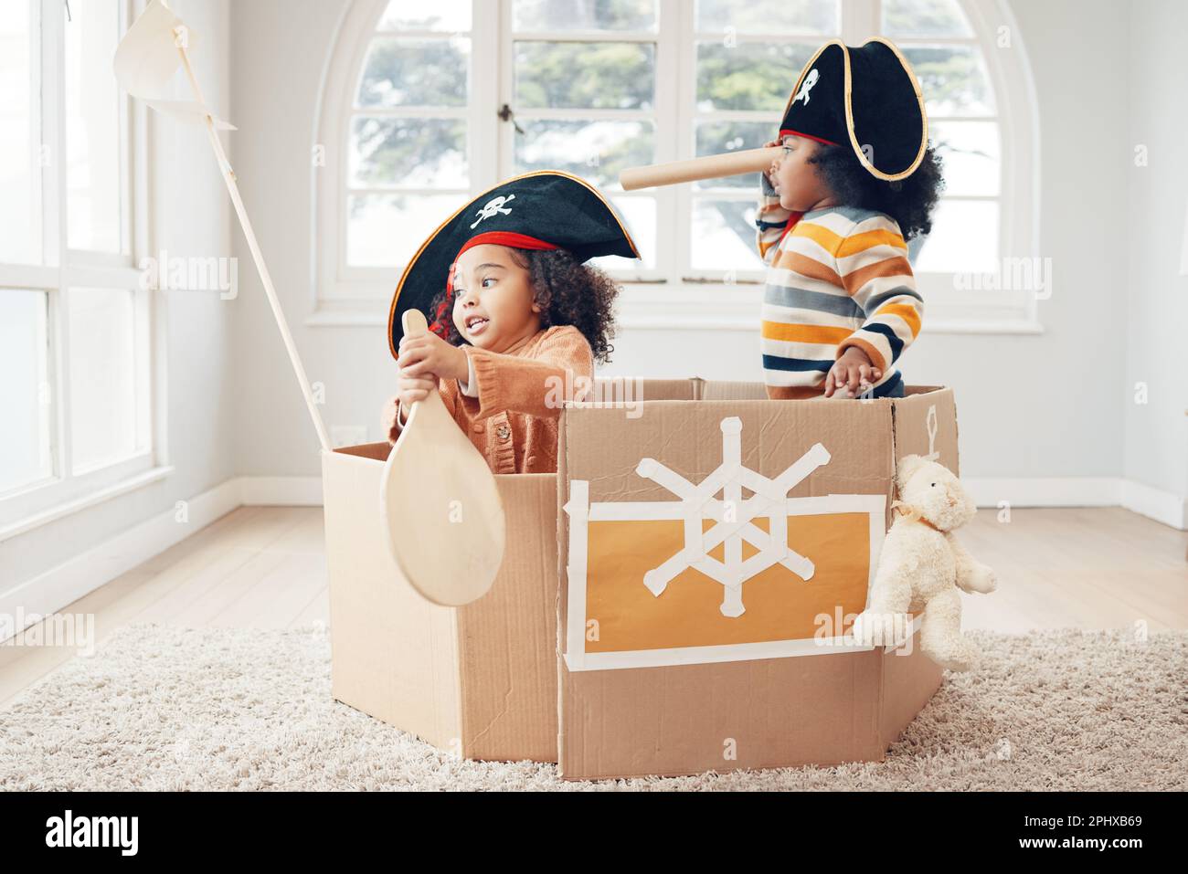 Playing, box boat and pirate children role play, fantasy imagine or ...