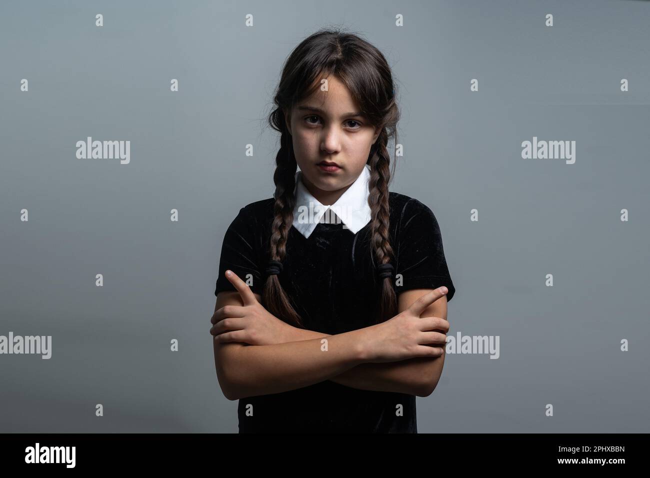 a girl in a Wednesday Addams costume style Stock Photo - Alamy