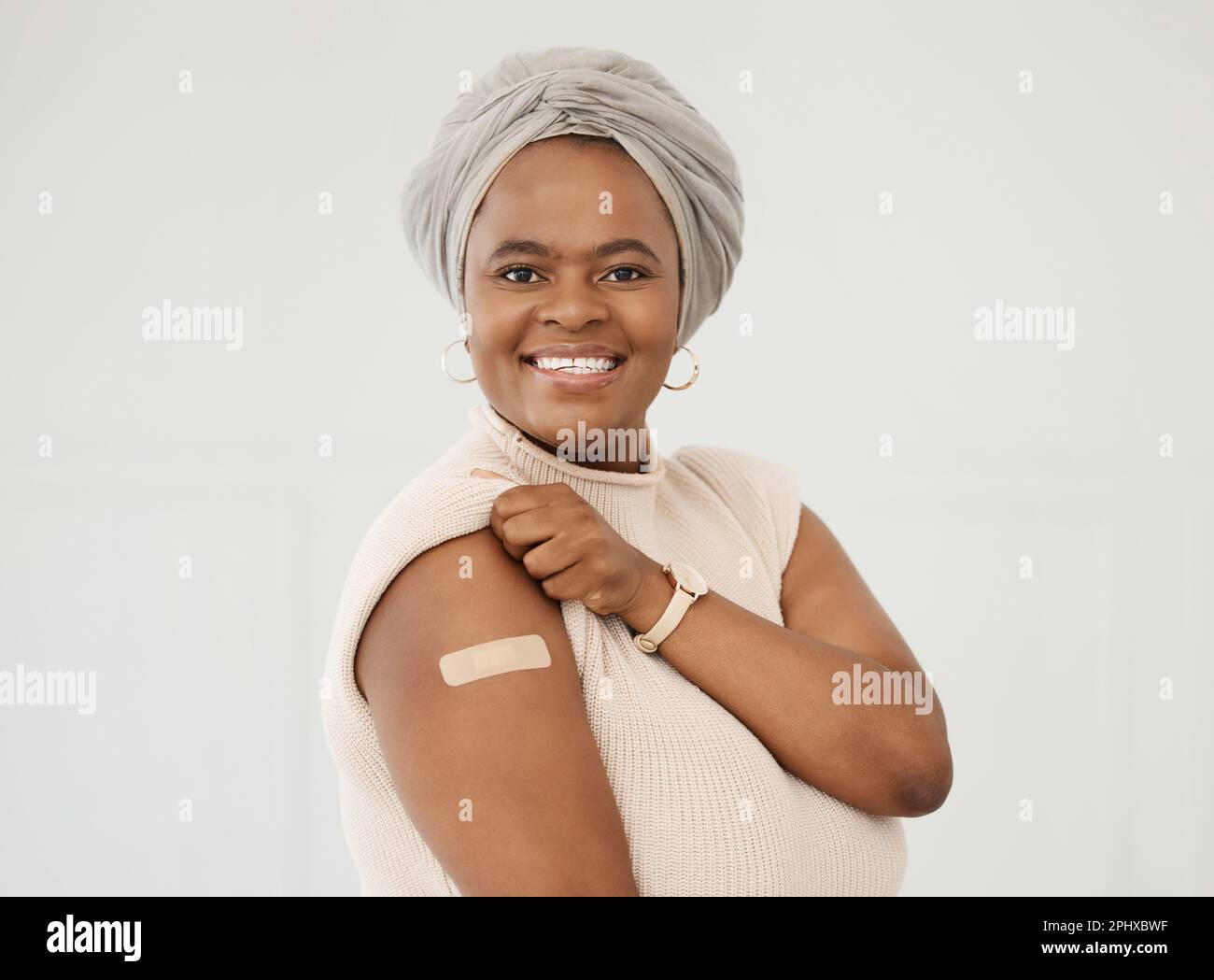 Black woman, smile and covid plaster on arm in studio for injection ...
