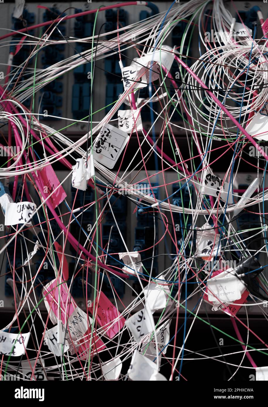 Tangled wires in electrical cabinet. Electric and mains wires are ...