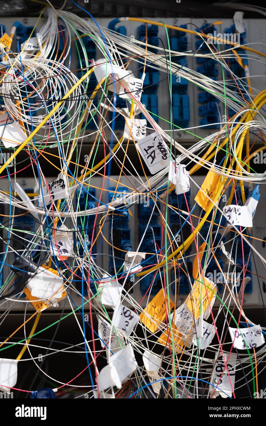 Tangled wires in electrical cabinet. Electric and mains wires are ...