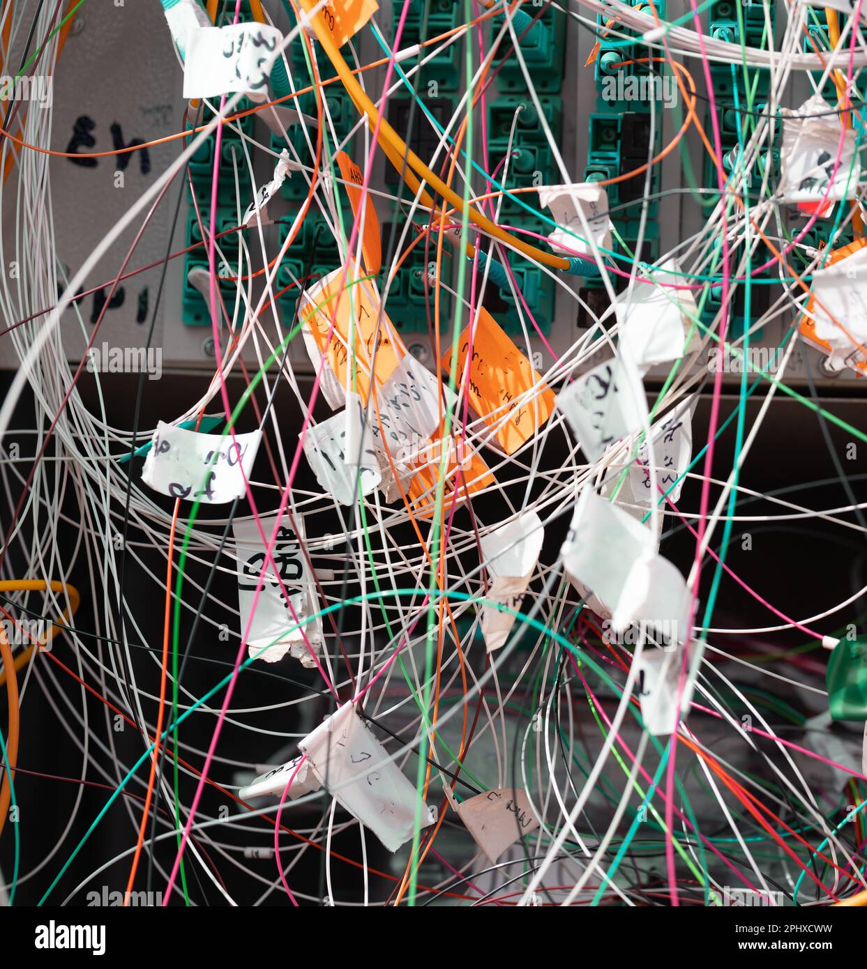Tangled wires in electrical cabinet. Electric and mains wires are ...
