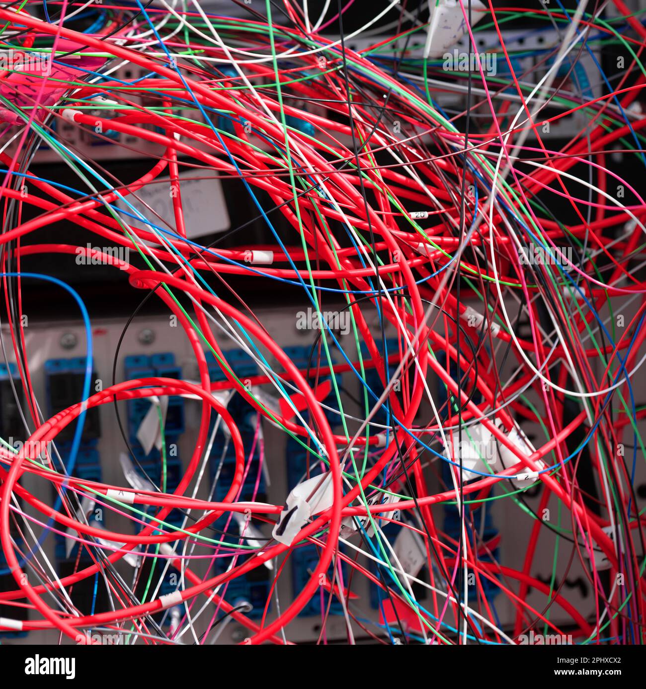 Tangled wires in electrical cabinet. Electric and mains wires are ...