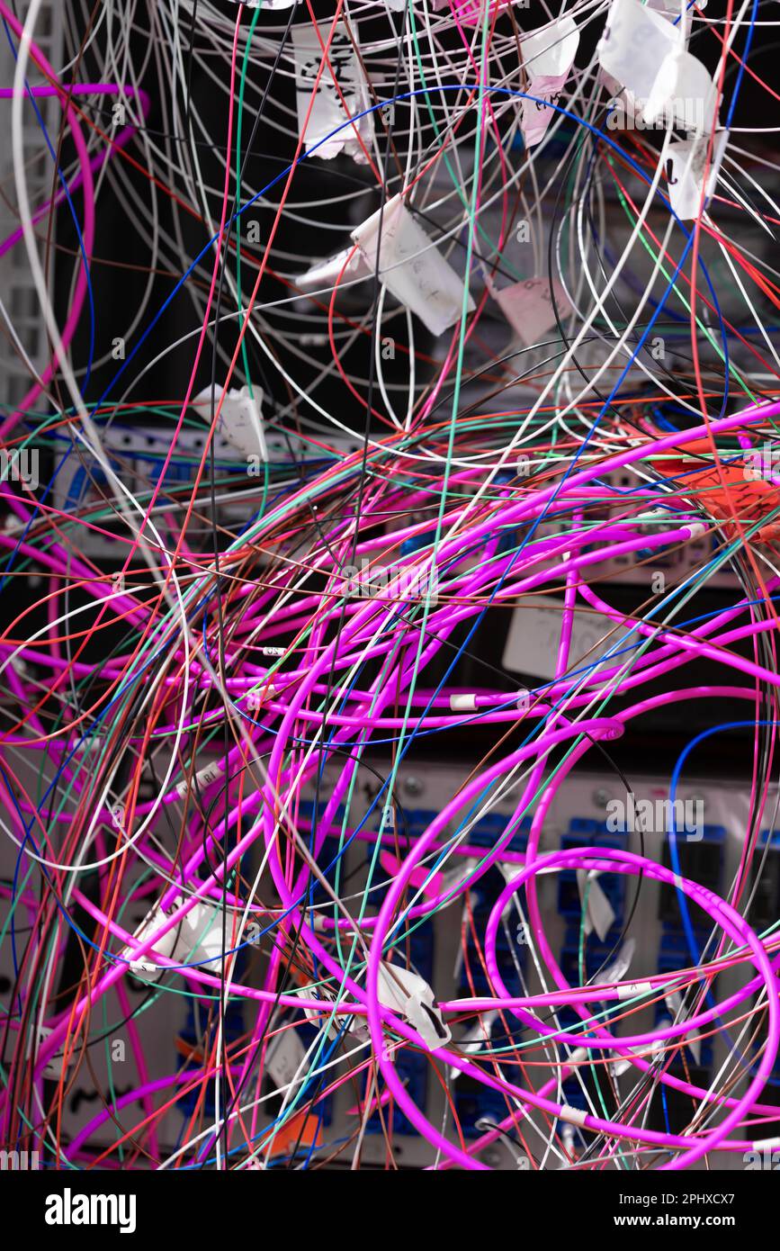 Tangled wires in electrical cabinet. Electric and mains wires are tangled. Concept - adjustment ...