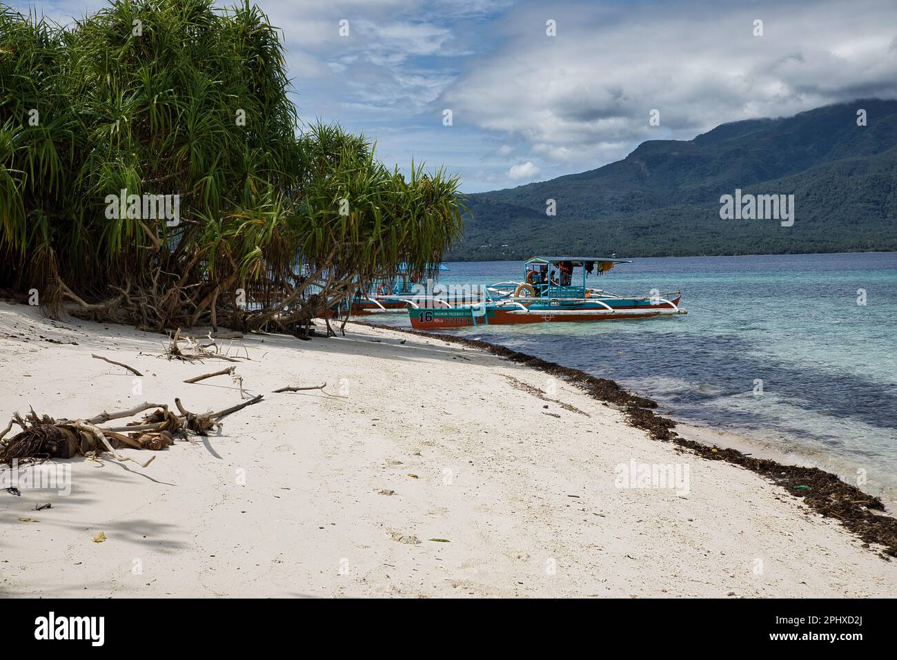 An idyllic white sand beach of tiny Mantigue Island near Camiguin in ...