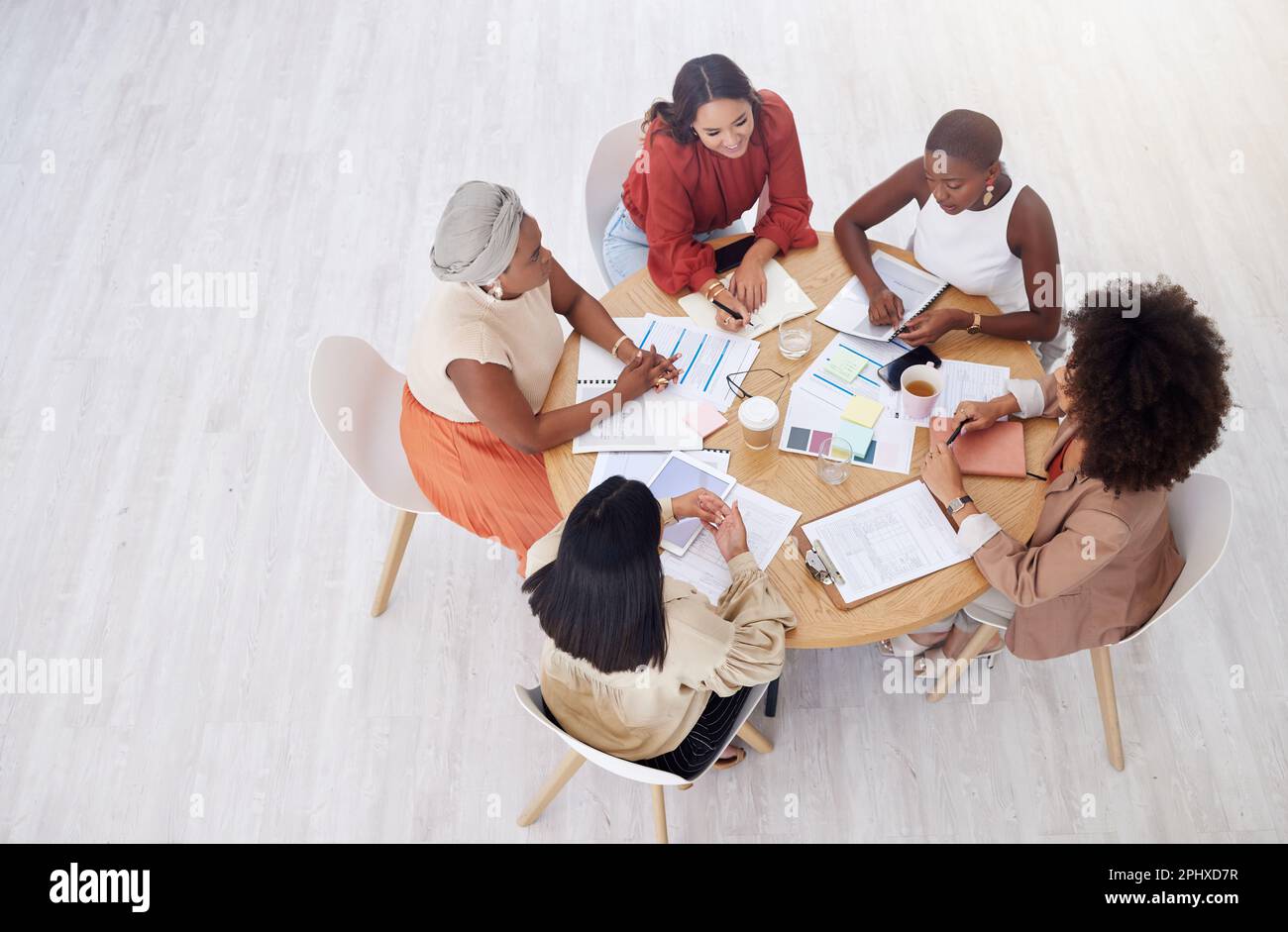 Collaboration, planning and overhead with a business women team reading ...