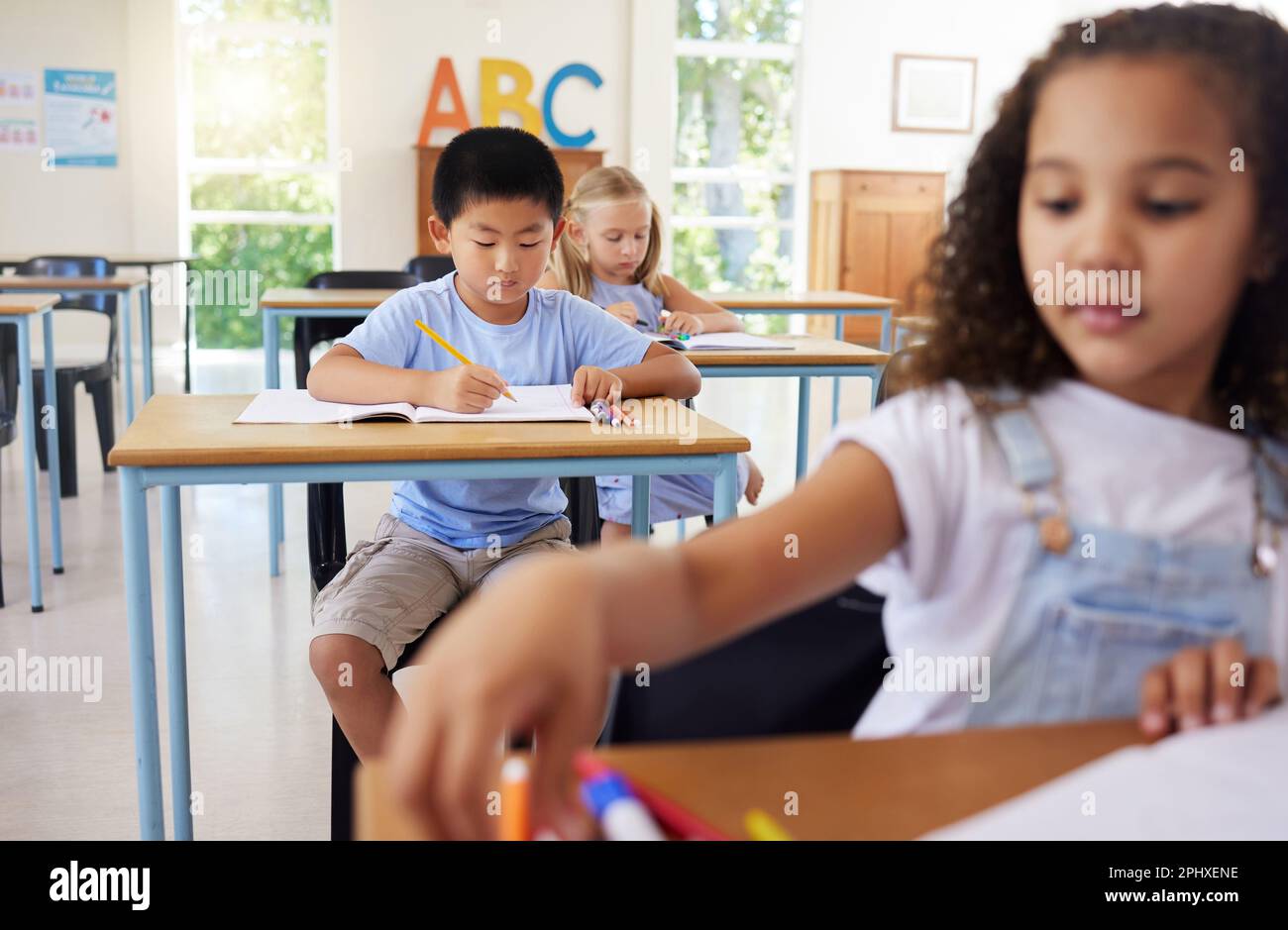 Education, drawing or Asian boy in classroom learning, exam or studying ...