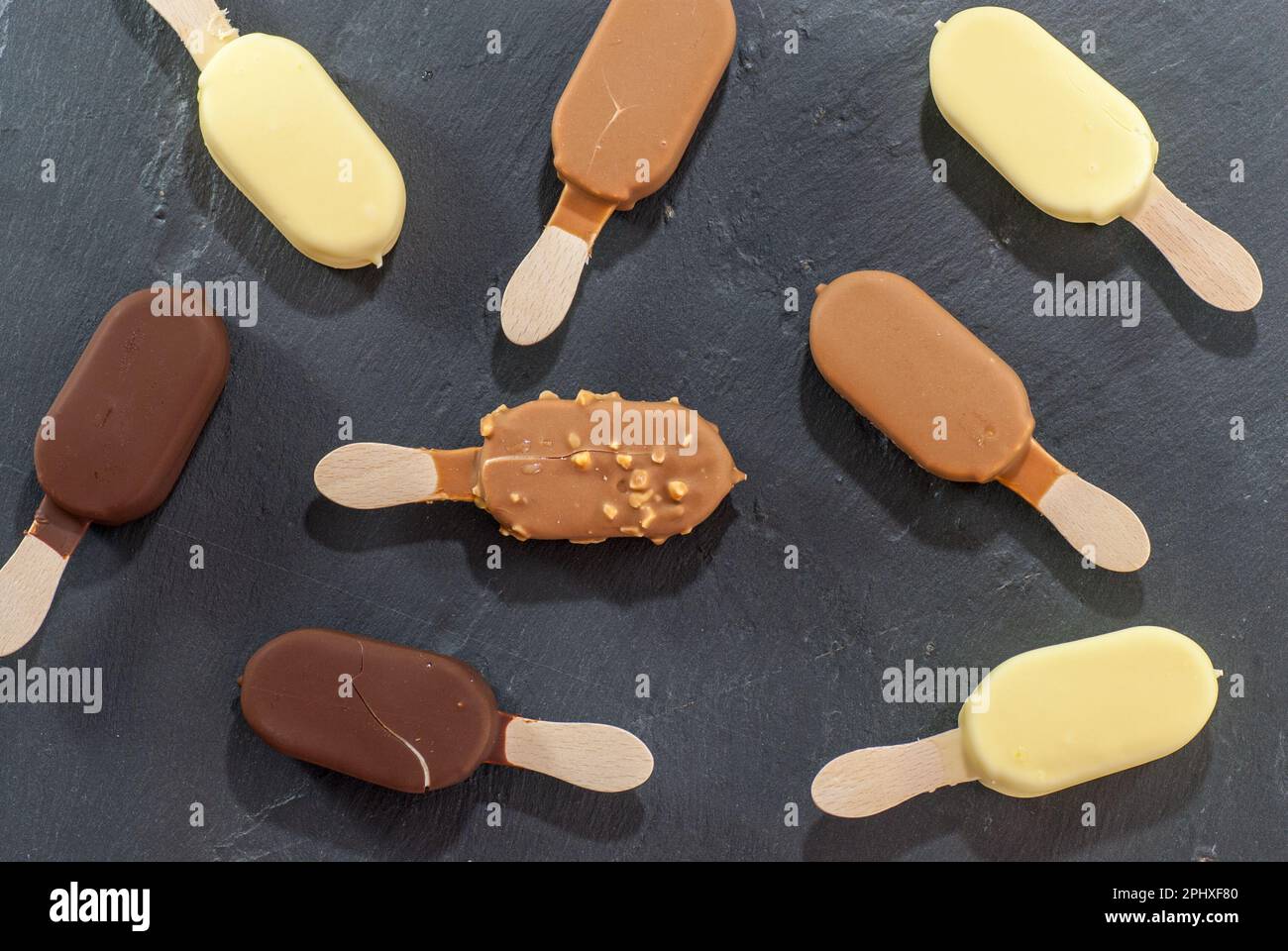 assorted mini ice creams on stick on black Stock Photo - Alamy
