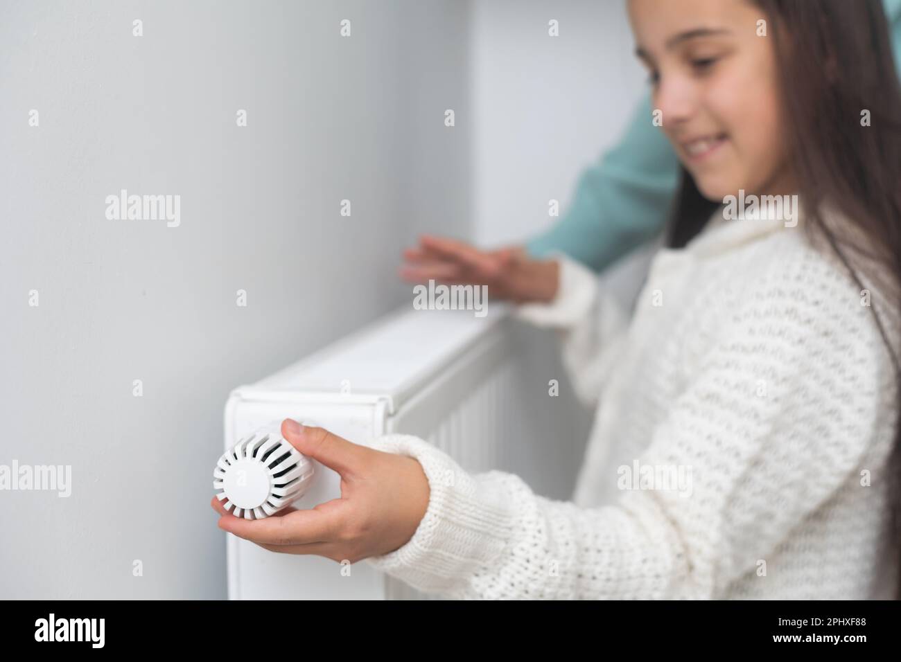 hands of a little girl near the radiator Stock Photo - Alamy