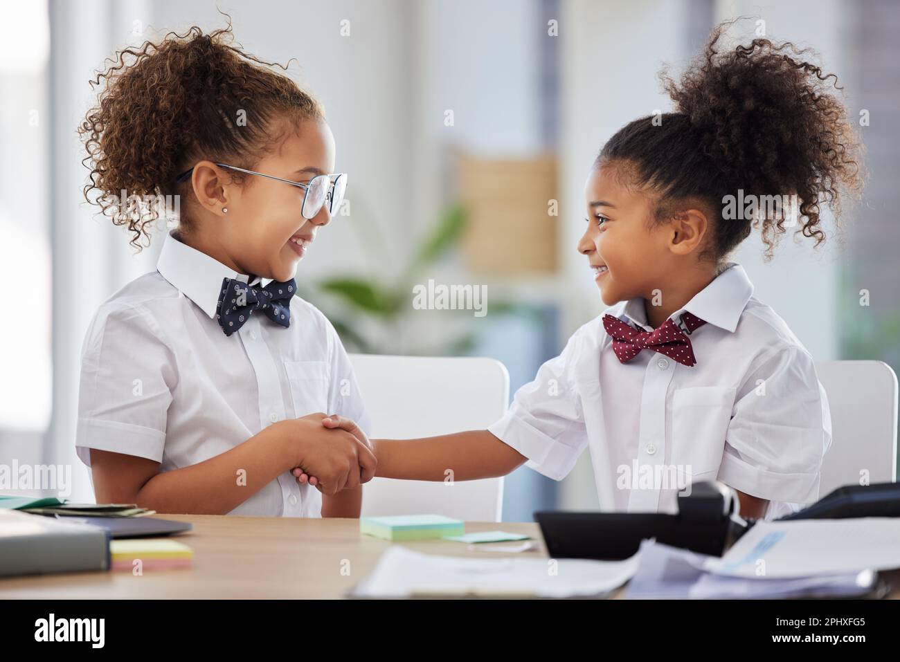 Handshake, playful and girls dressed as employees, welcoming and ...