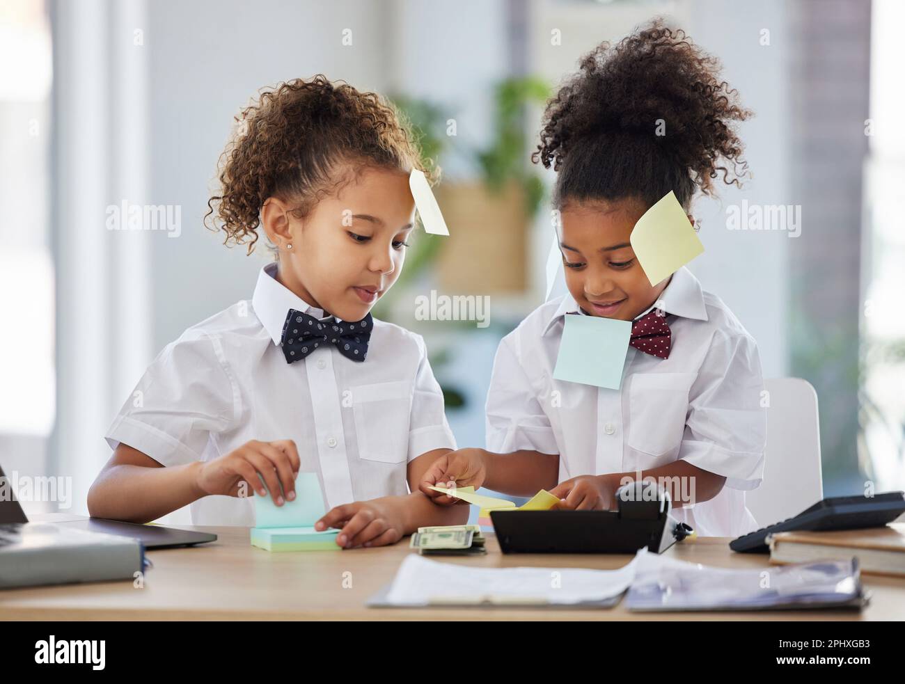 Children, together and playing office with sticky note at desk with ...