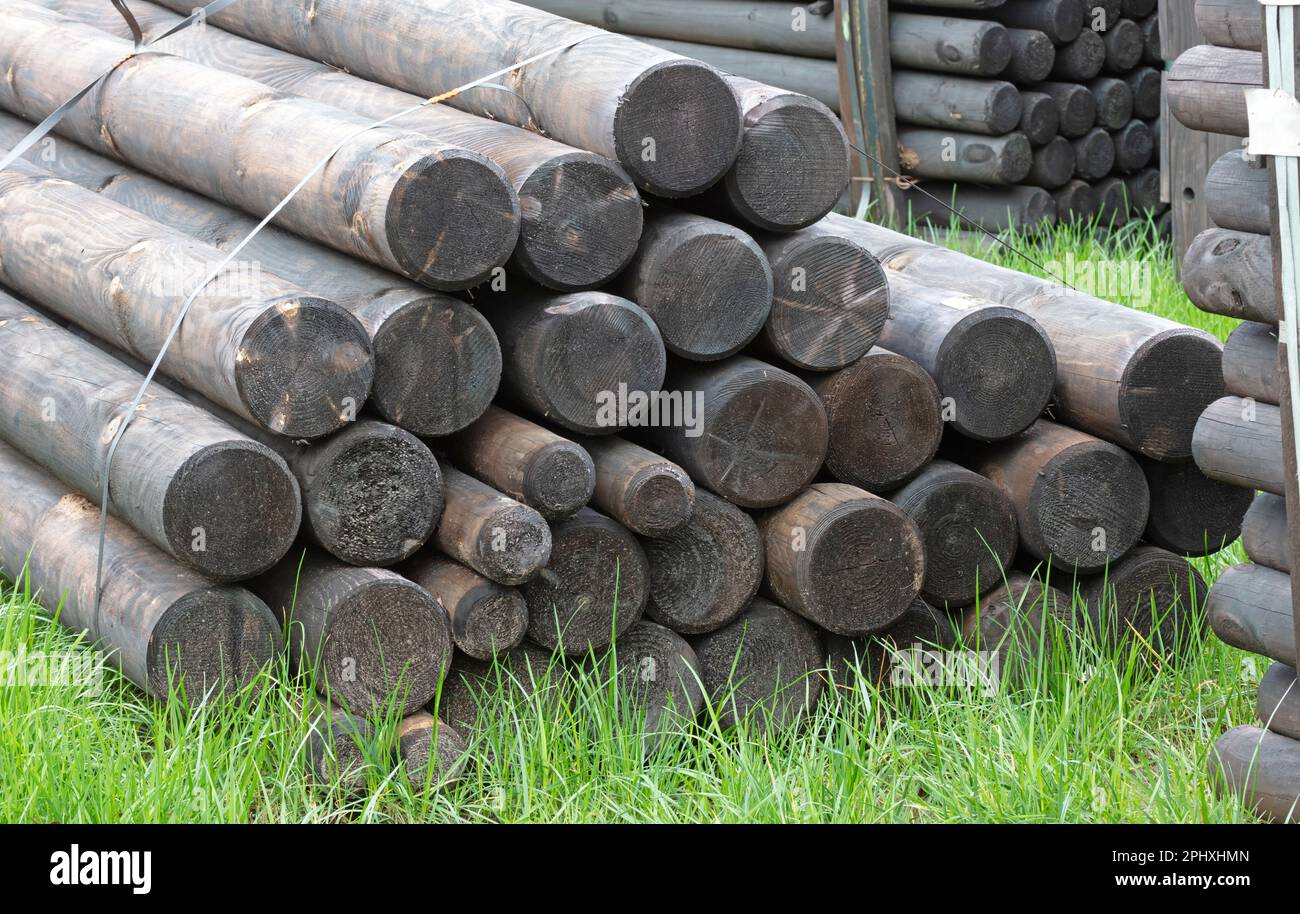 Pile of wooden poles for construction, selective focus Stock Photo - Alamy