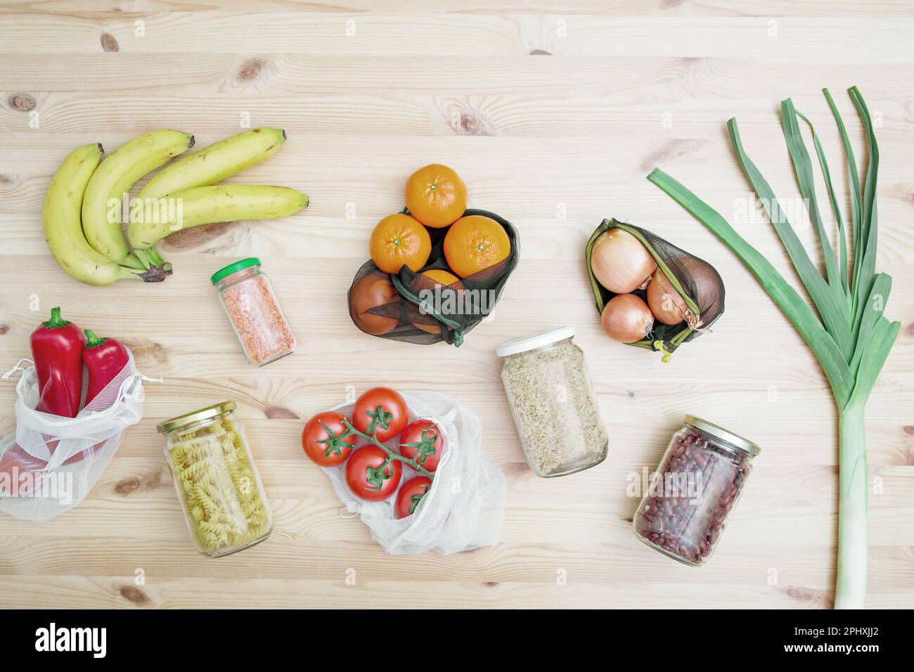 Vegetables and fruits in reusable bags and cereals, legumes, pasta in ...