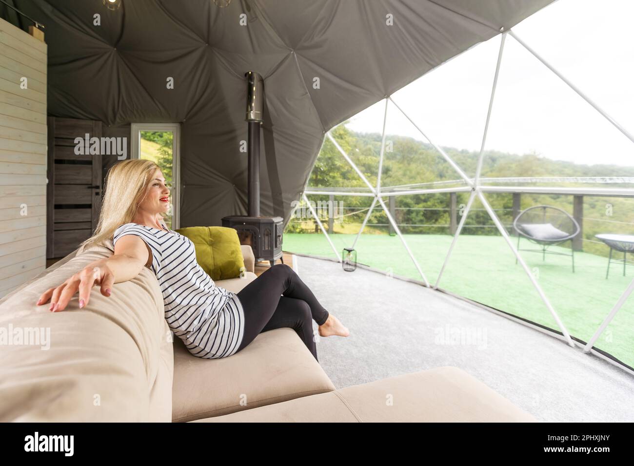 a woman enjoys solitude inside of a transparent bubble hotel Stock ...
