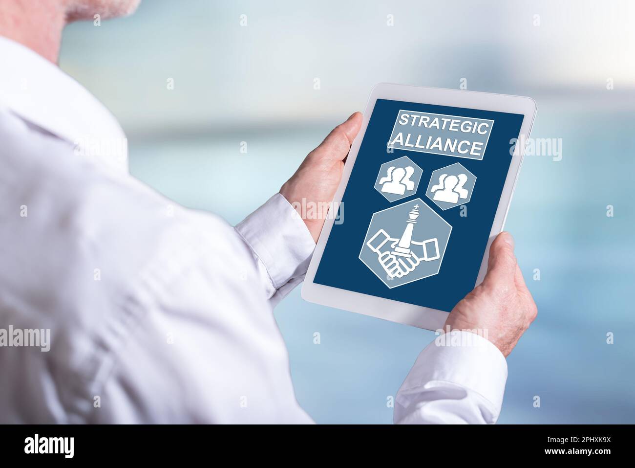 Tablet screen displaying a strategic alliance concept Stock Photo - Alamy