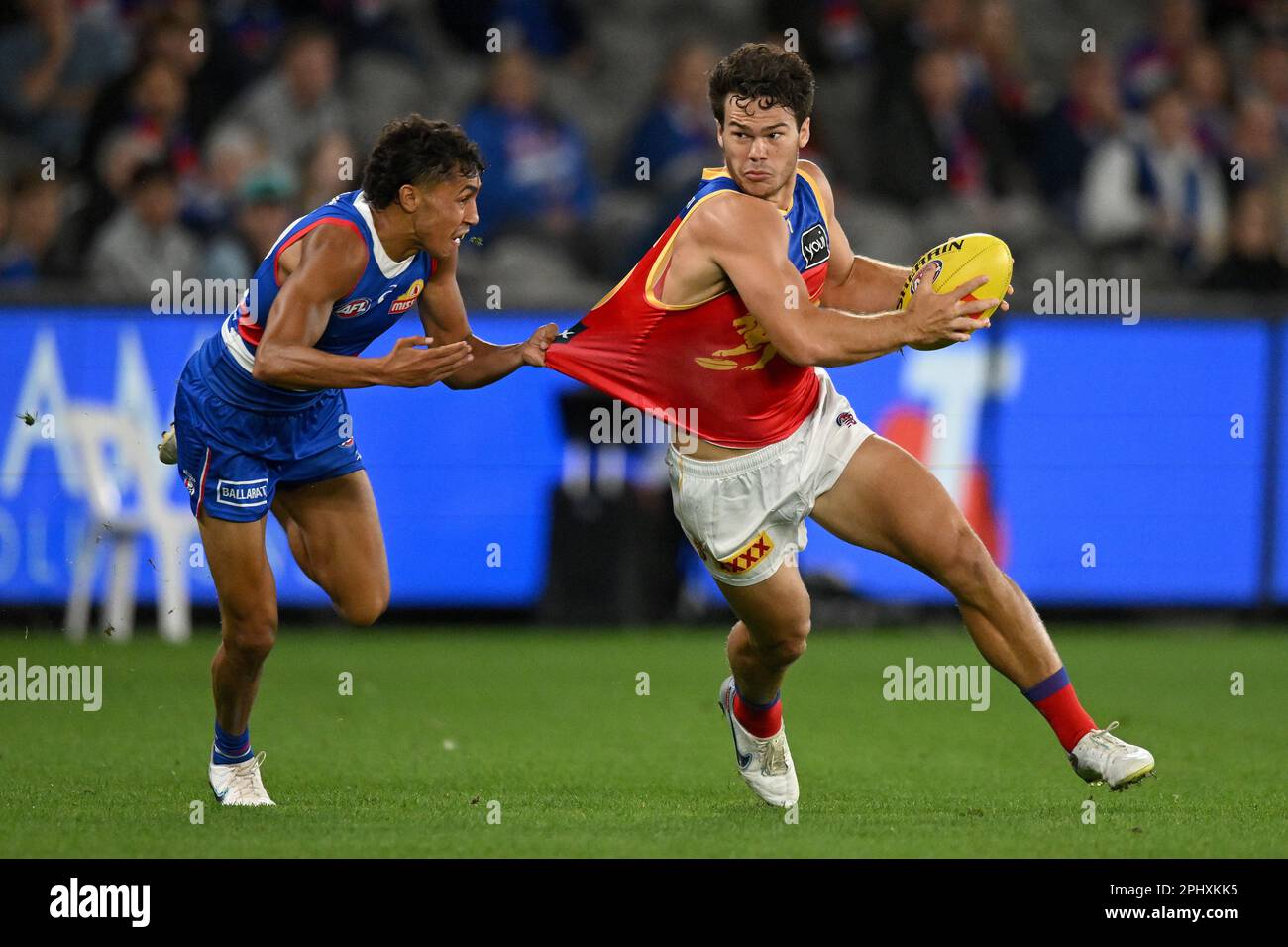 Roarke Smith of the Bulldogs tackles Cam Rayner of the Lions during the ...