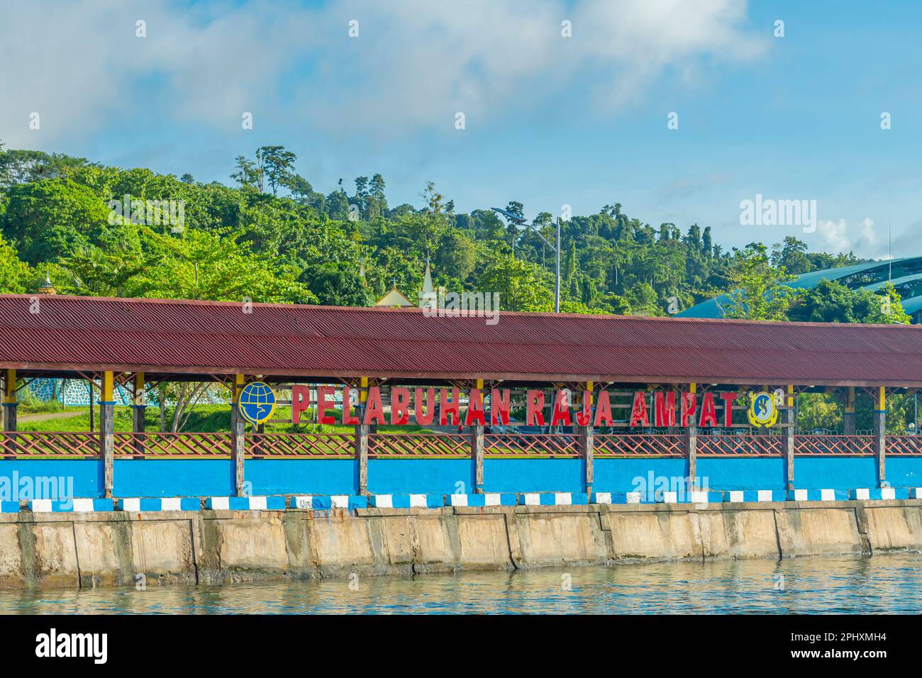 The pier with the signn Pelabuhan - harbor- Raja Ampat of Waisai at ...