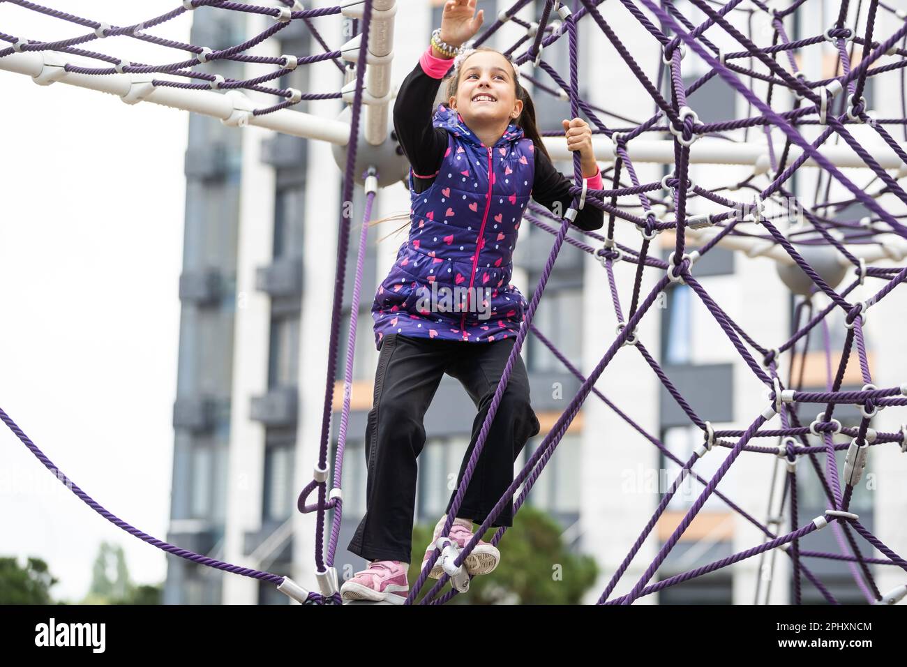 Cute teenage girl in the rope labyrinth kid park attraction Stock Photo ...