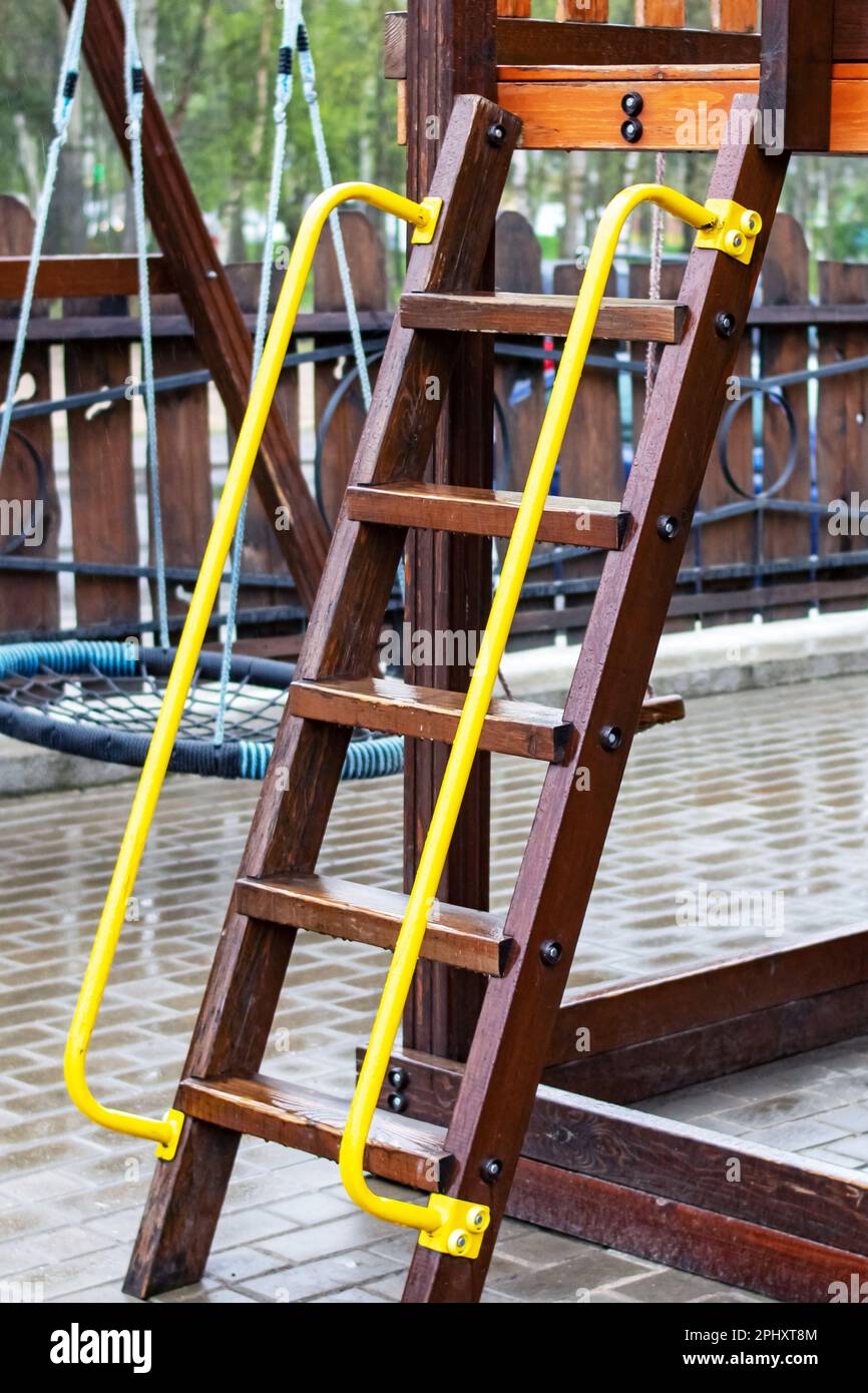 Wooden stairs in playground wet in rain Stock Photo - Alamy