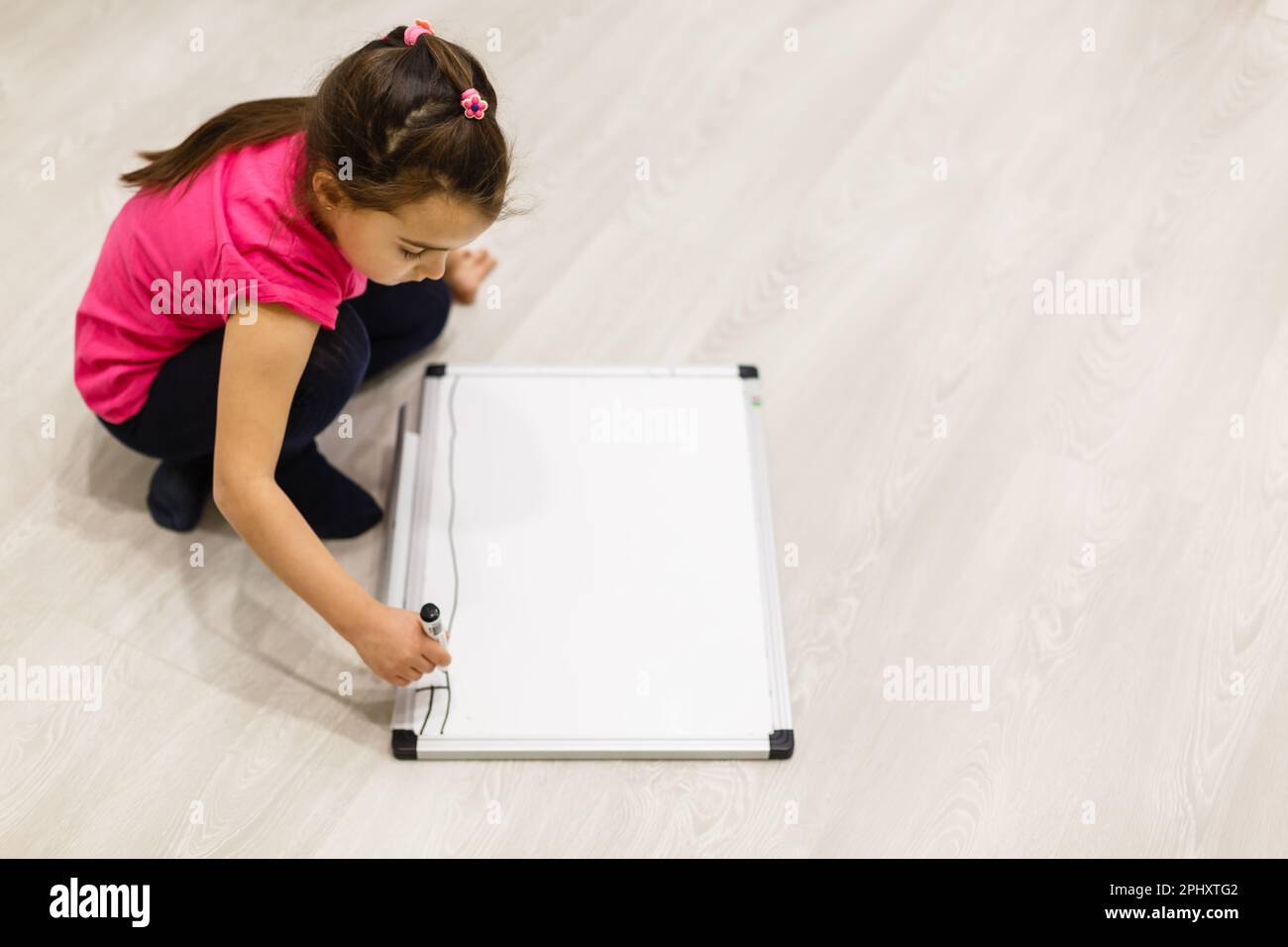 Image of young cute little child. Baby girl in class. Child stands near ...